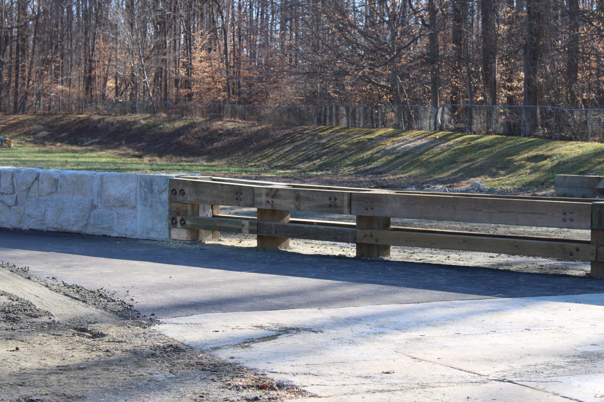 Median Steel-Backed Timber Guardrail to Stone-Faced Median Barrier Transition - Task Force 13